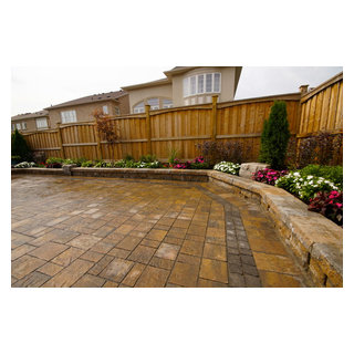 multi- level interlock patio with retaining walls and fencing - Modern ...