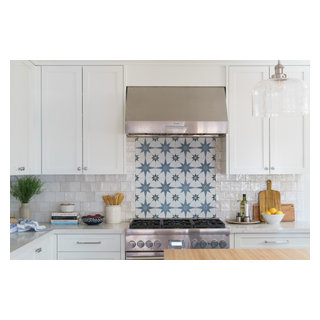 The focal point of the kitchen with a decorative tile at the range ...