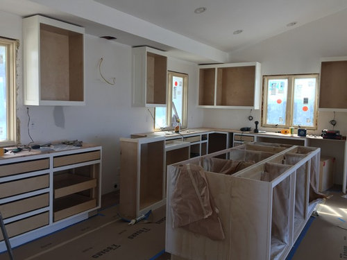 Upper cabinet symmetry around kitchen windows