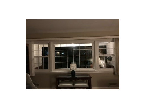 Two large picture windows in front of house.