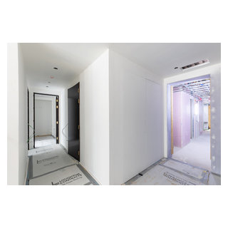 The minimalist finish of the wall access panels. - Modern - Hall ...