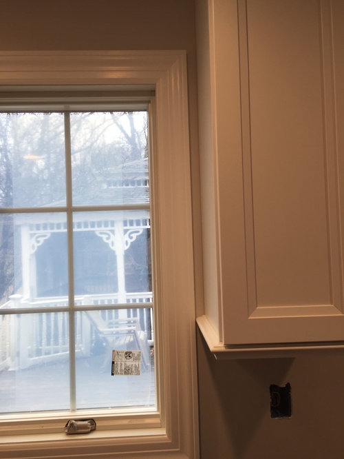 Light rail molding is overlapping window trim on one side.