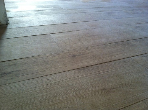 Bad tile installation or warped/bent tiles?