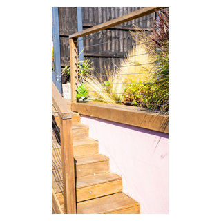 Wire balustrade and wooden stairs in split level garden - Contemporary ...