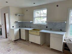 quartz floating shelf along one entire wall in kitchen