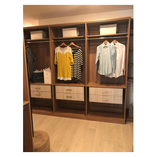 A Luxury Walk-In Closet Designed with Drawers and Long Hang Shelves ...