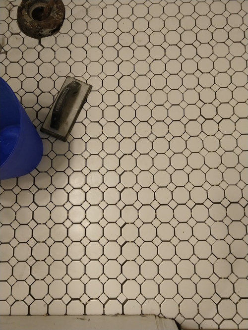 Misaligned honeycomb floor tile. Contractor is going to grout tomorrow