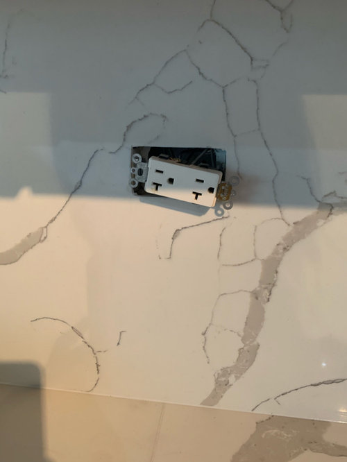 Outlet covers on quartz backsplash