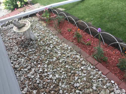 Flower/rock bed in front out house?