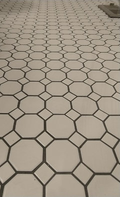 Misaligned honeycomb floor tile. Contractor is going to grout tomorrow