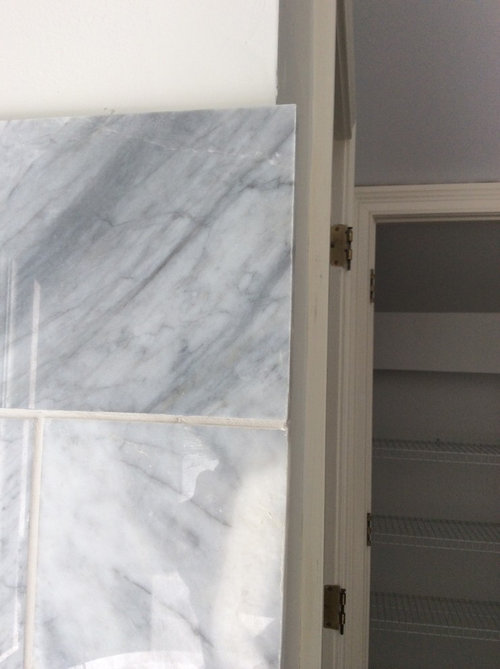 New marble hangs over the edge of poorly built old wall!