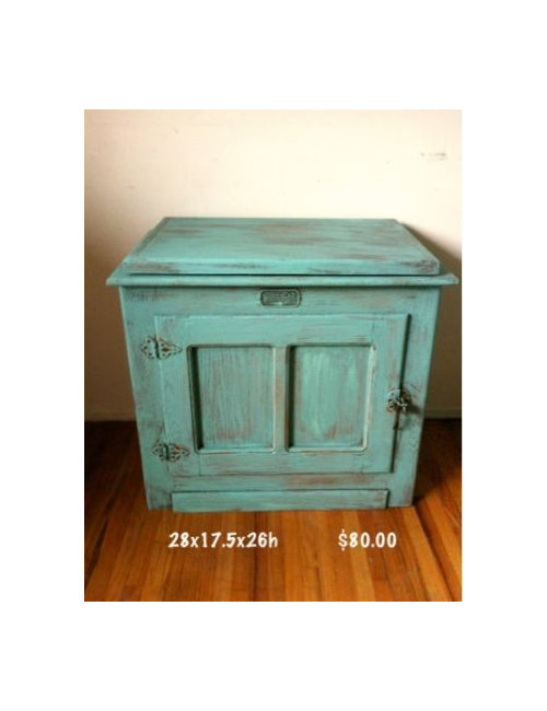 Turquoise patina console in dark wood room with orange and blue accents