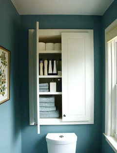 Mirrored doors on both an over the toilet cabinet medicine cabinet