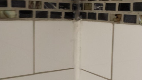 Help repairing poor caulking job in shower