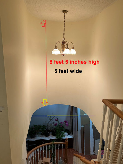 Lighting in high ceiling above stairs