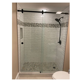 3x12 textured subway tile, with a darker mosaic band and pebble shower ...