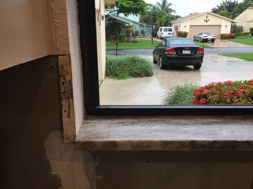 Tiling around a window.