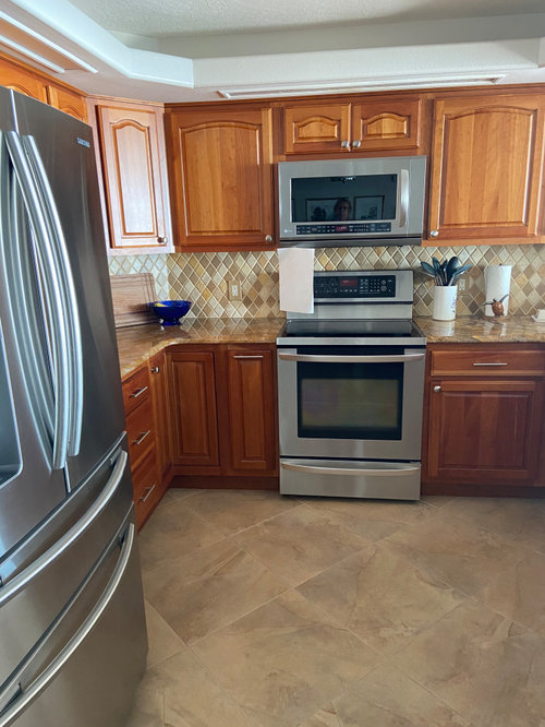 moderning tuscan era kitchen, what countertop with busy floor tiles?