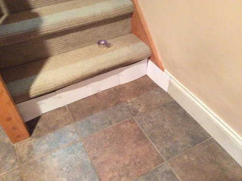 Baseboard transition from floor to stairs
