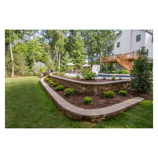 Creating a pool area on a sloped backyard - New York - by Monello ...
