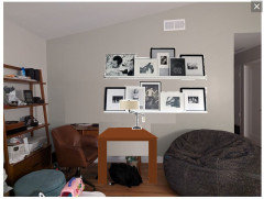 Large gallery wall behind computer desk