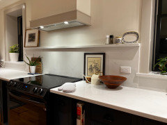 quartz floating shelf along one entire wall in kitchen