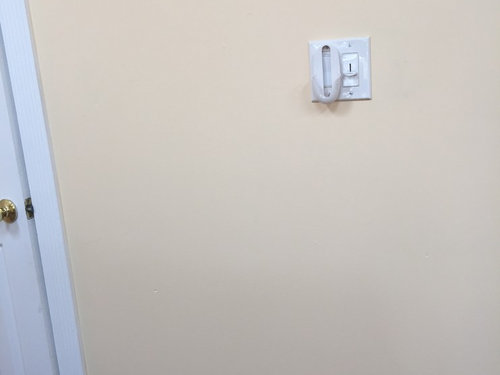 How do I hang pictures, art around light switches??