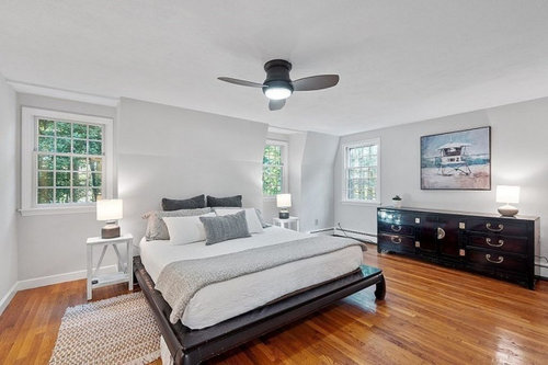Nightstand or built-in ideas with windows next to bed.