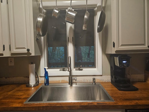 Backsplash placement with uneven window/cabinets