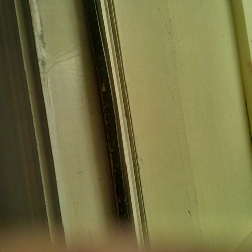 Replacing stripping on front door w/ wood trim (and small slit).