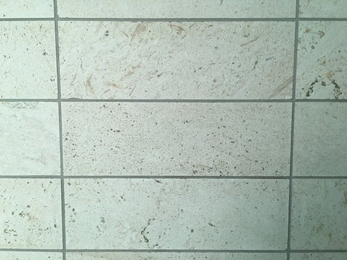 Help! Limestone tile stained by grout.