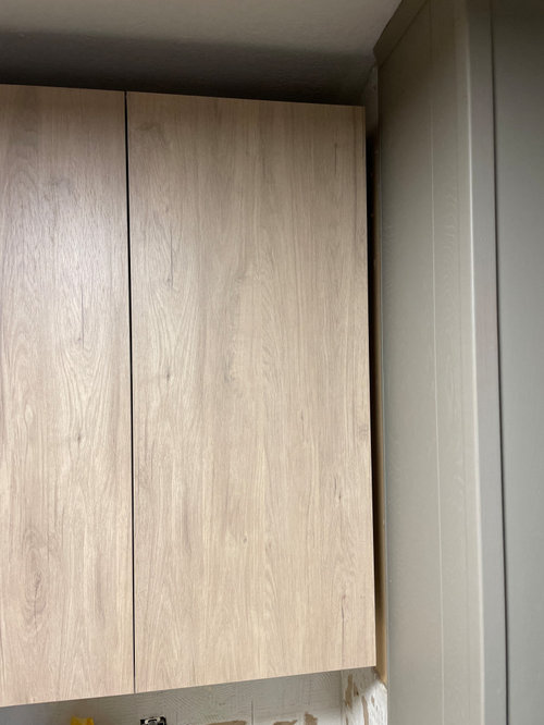 Infill gap ideas for spaces around cabinets tween walls and ceiling?