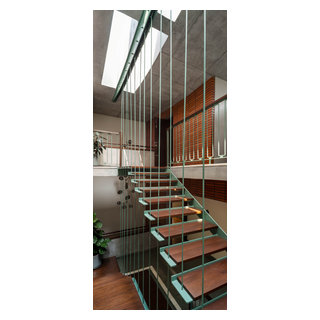 A floating boat-shaped roof with skylight supporting the main staircase ...