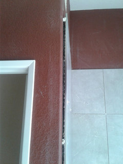 1/2" open gap between wall tiles and wall - how to fix?