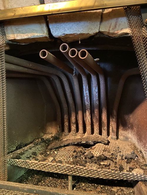 Old cabin with a weird fireplace..anyone know what these pipes are?