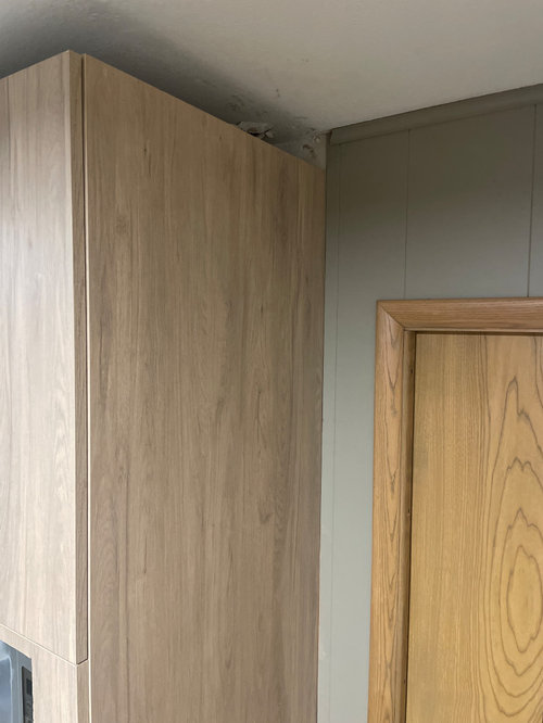 Infill gap ideas for spaces around cabinets tween walls and ceiling?