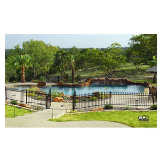 Fenced Freeform Pool with Rock Waterfall Wall - Austin - by Ocean Quest ...