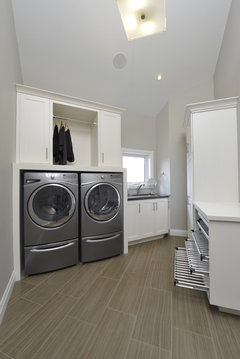 Elevated washing machines above cabinetry