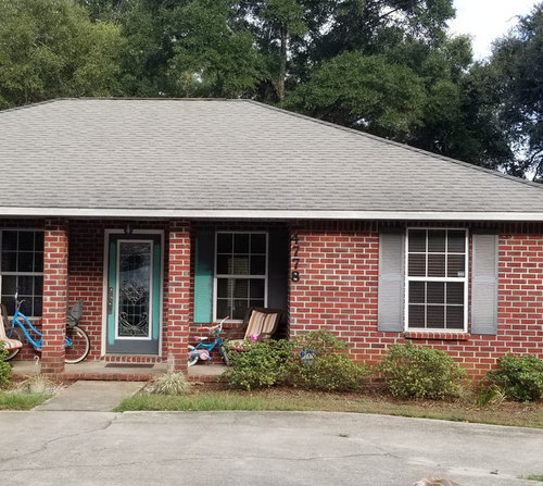 Small, red-brick home in need of coastal color