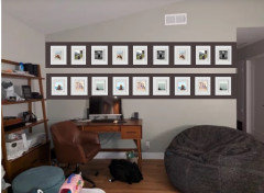 Large gallery wall behind computer desk