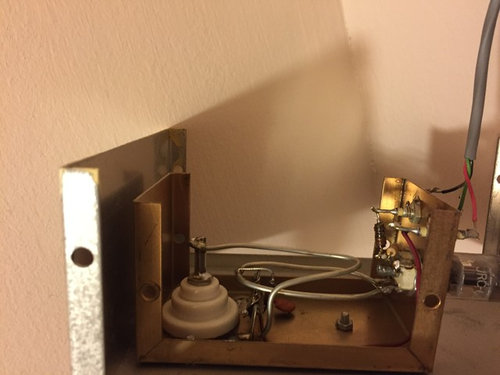 Weird self-destruct-looking switch/light on wall of old house