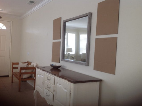 Hanging a mirror and pictures above a sideboard table