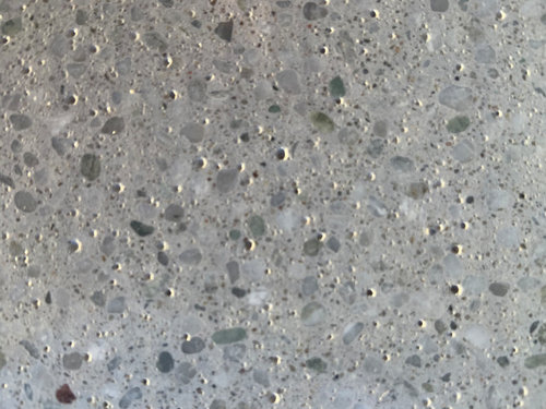 Numerous pinholes in new exposed aggregate concrete floor