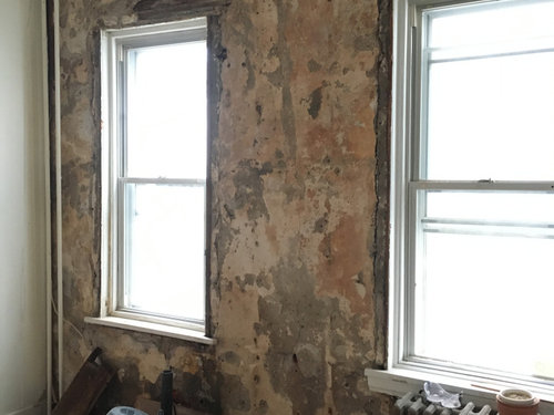 fix plaster or drywall over? (severely damaged exterior facing wall)