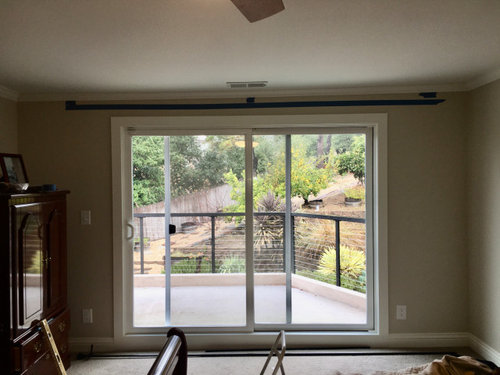 Center curtains over slider or wall?