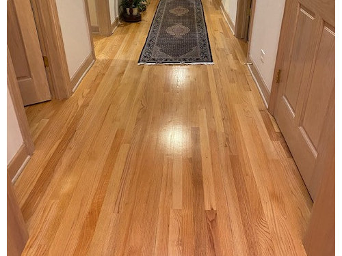 What color wood flooring with light wood baseboard, trim & doors