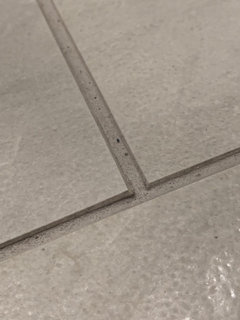 How do I fix uneven grout color and low grout joints?