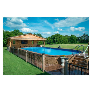 Stealth semi-inground vinyl pool with stacked landscape stone and stone ...