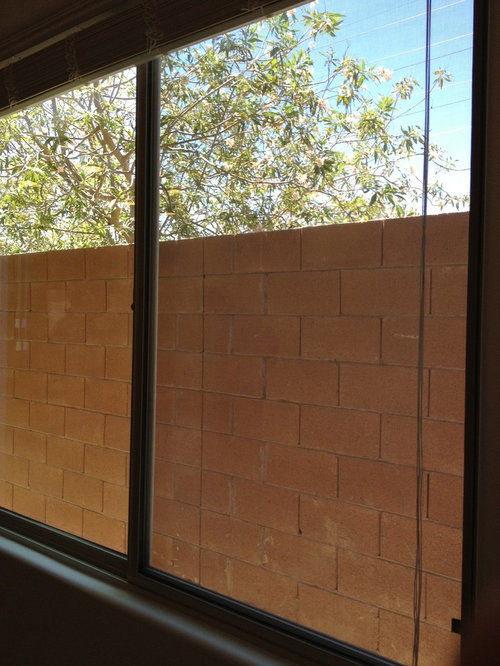 Window looking out to a small space between houses