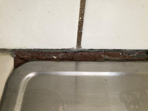 Grout Cracking and Crumbling Behind Kitchen Sink